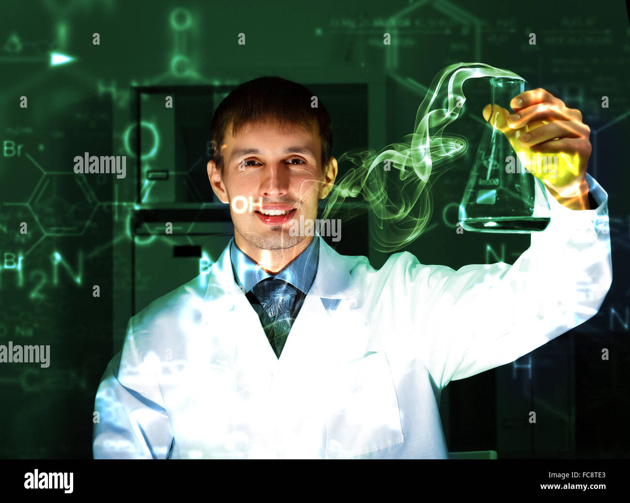 Young chemist in white uniform working in laboratory Stock Photo - Alamy