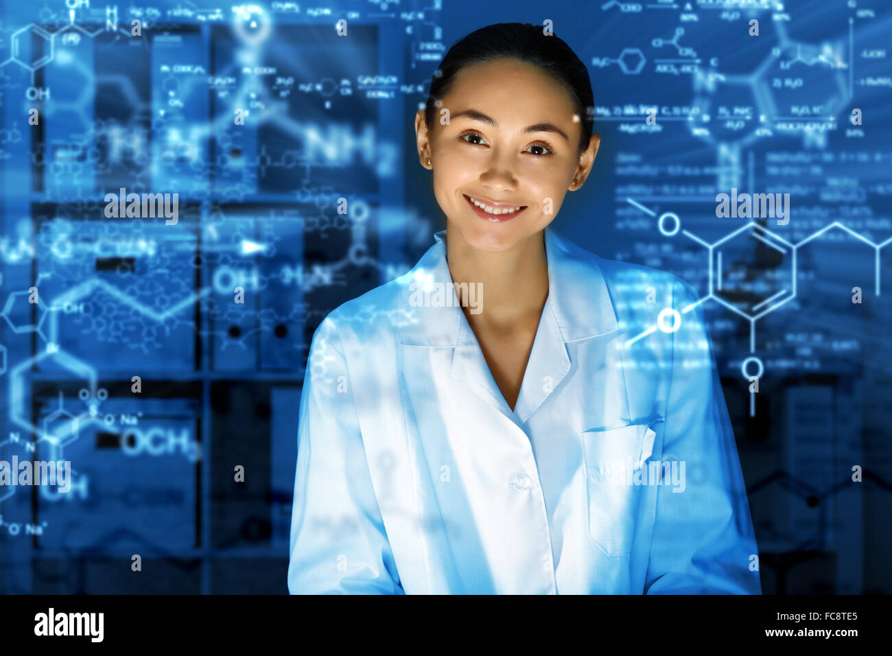 Young chemist in white uniform working in laboratory Stock Photo - Alamy