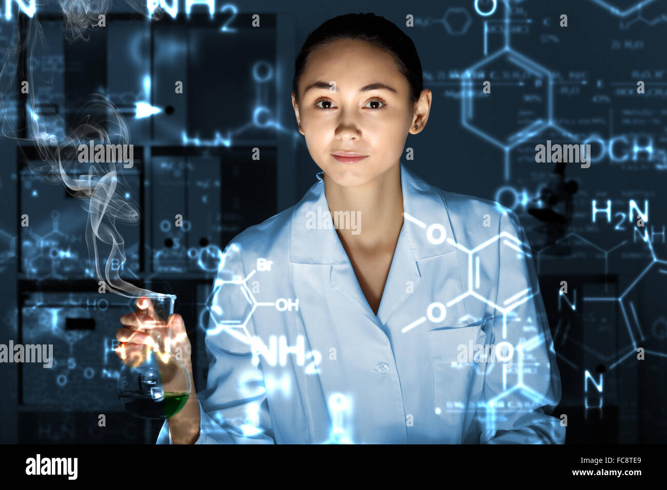 Young chemist in white uniform working in laboratory Stock Photo - Alamy