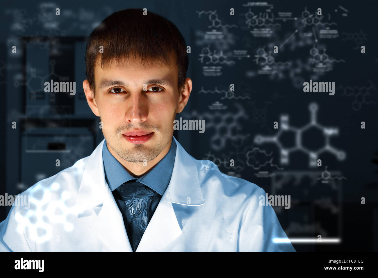 Young chemist in white uniform working in laboratory Stock Photo - Alamy