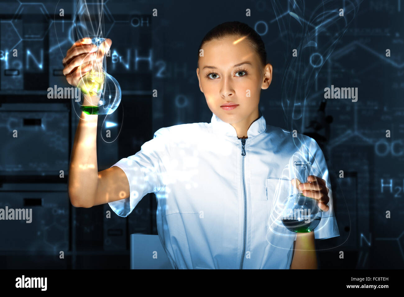 Young chemist in white uniform working in laboratory Stock Photo - Alamy