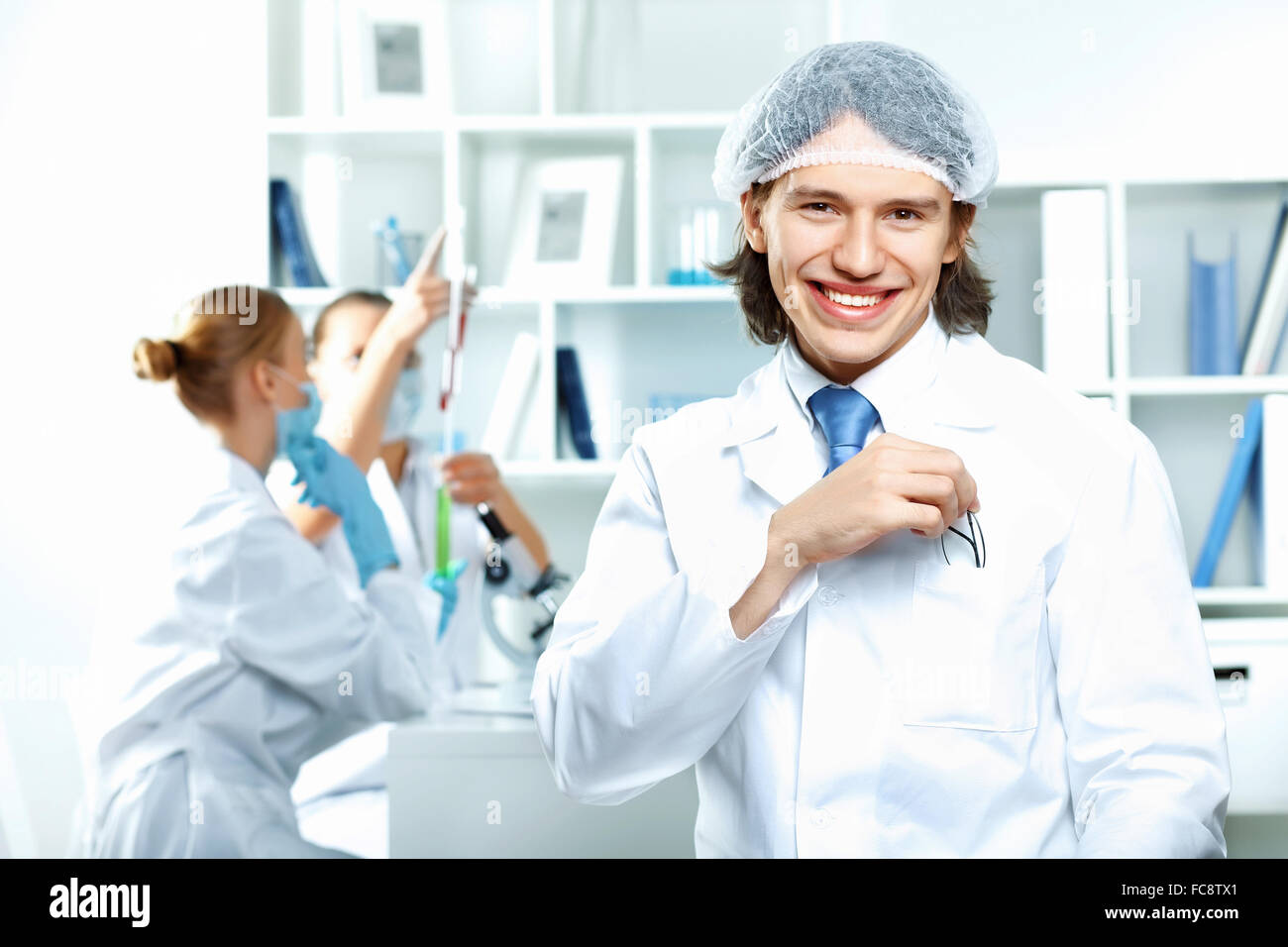 Young scientists in white uniform working in laboratory Stock Photo - Alamy