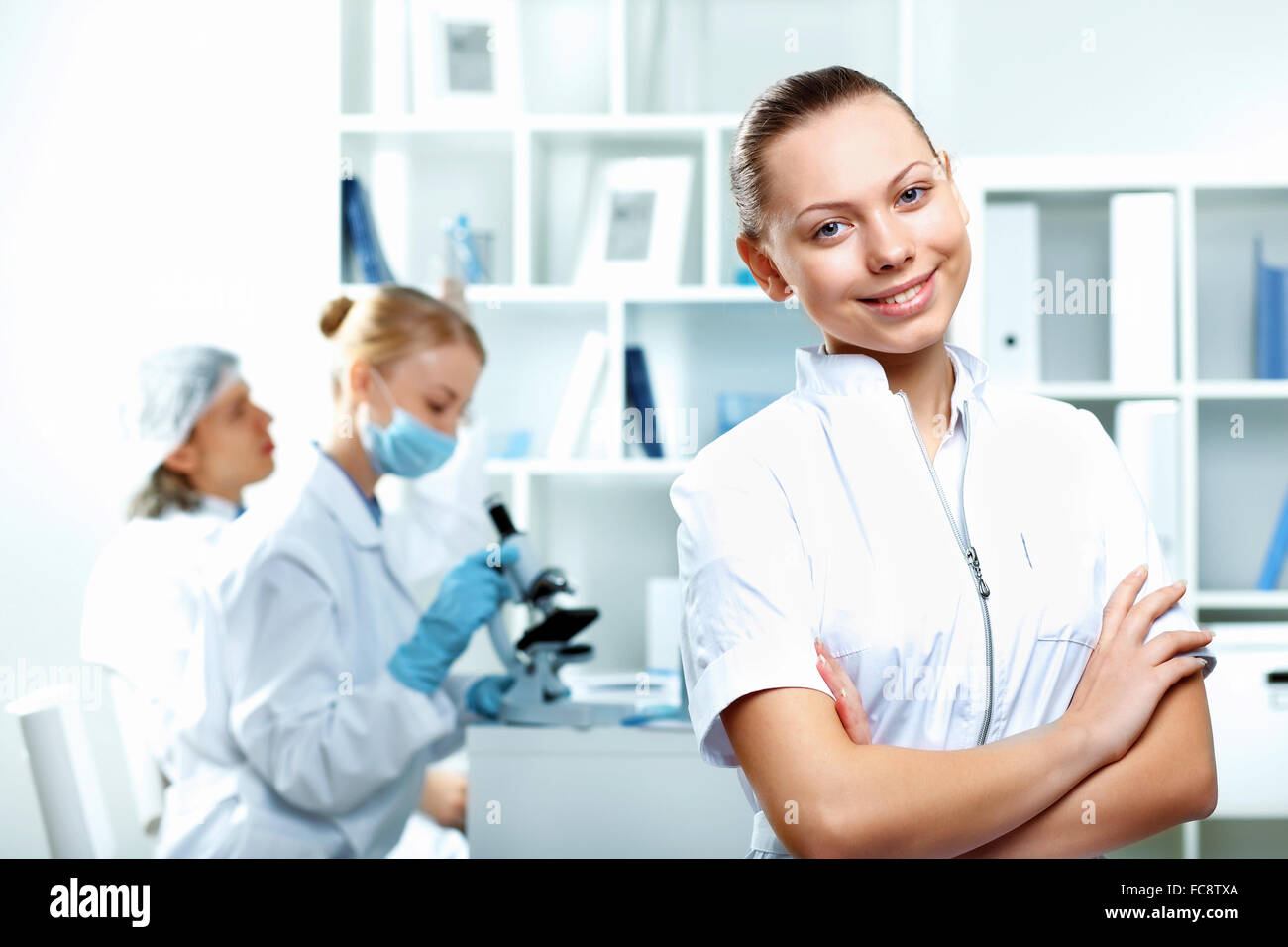 Young scientists in white uniform working in laboratory Stock Photo - Alamy