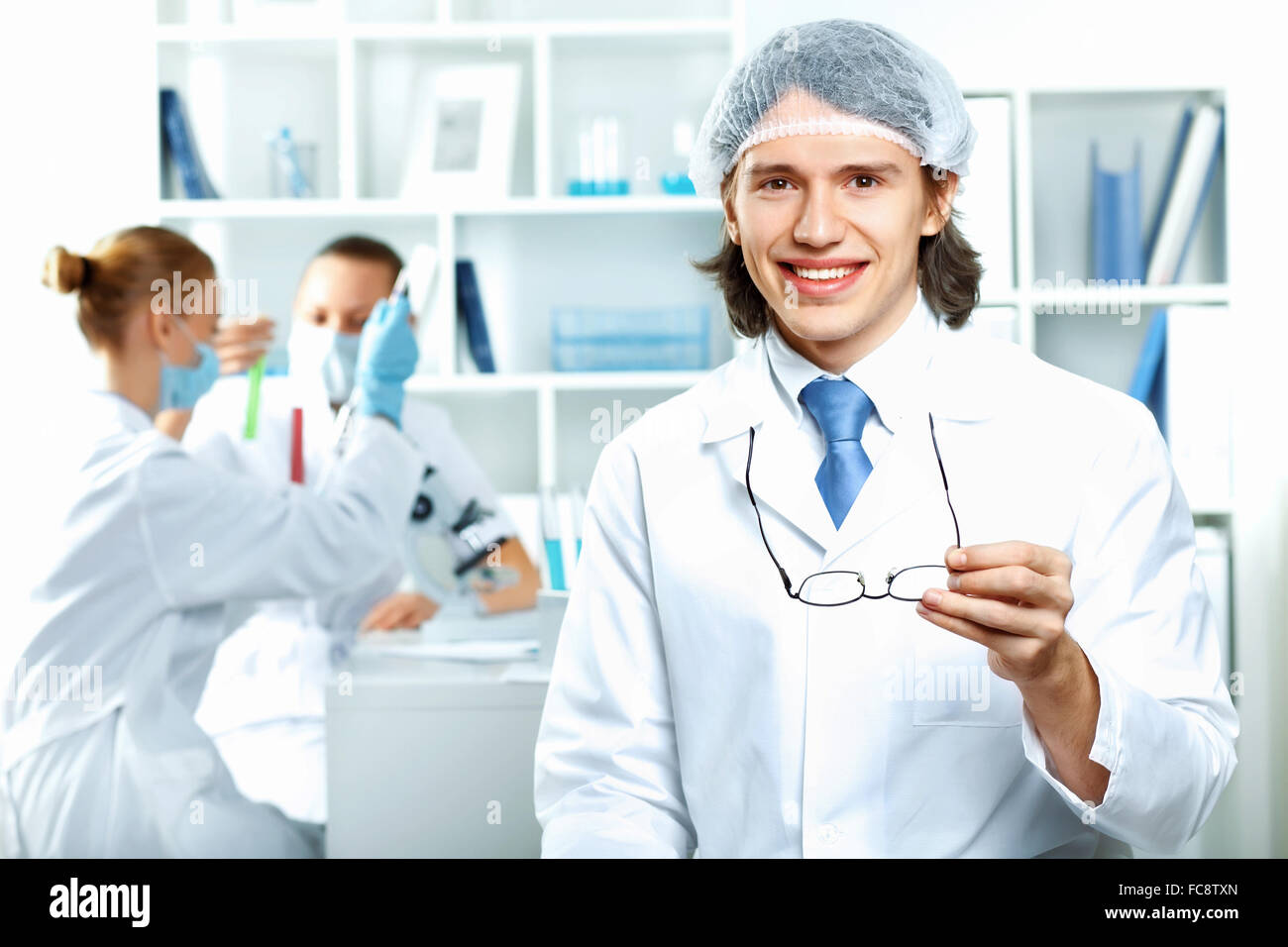 Young scientists in white uniform working in laboratory Stock Photo - Alamy