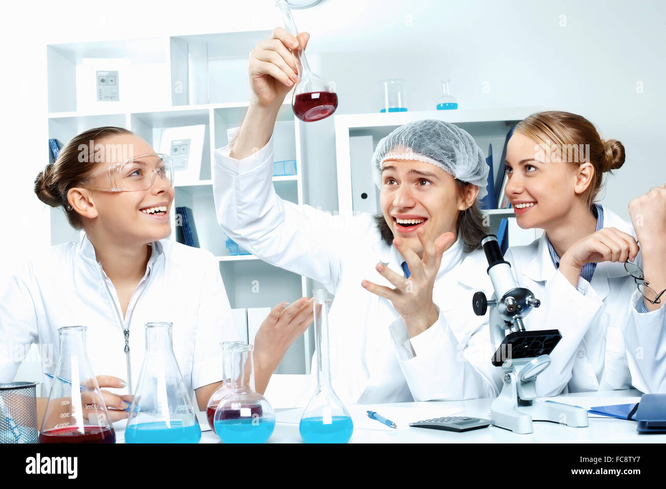Young scientists in white uniform working in laboratory Stock Photo - Alamy