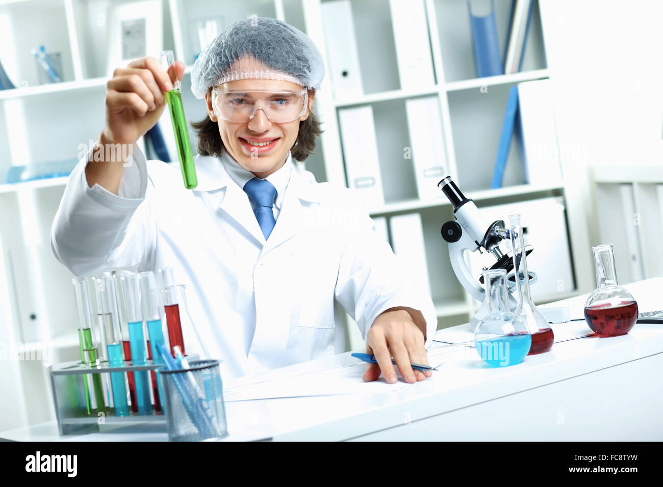 Young scientist in white uniform working in laboratory Stock Photo - Alamy