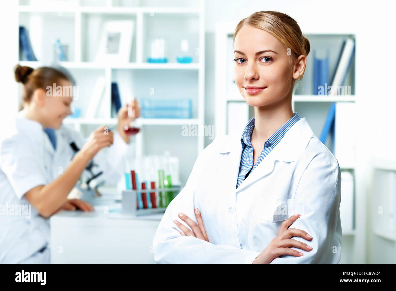 Young scientists in white uniform working in laboratory Stock Photo - Alamy