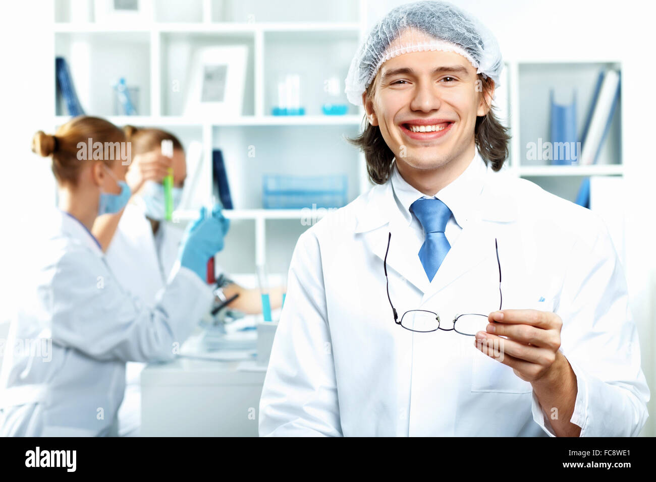 Young scientists in white uniform working in laboratory Stock Photo - Alamy