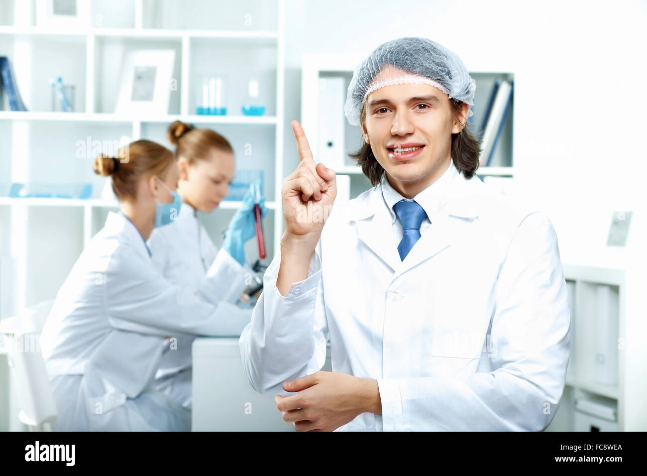 Young scientists in white uniform working in laboratory Stock Photo - Alamy