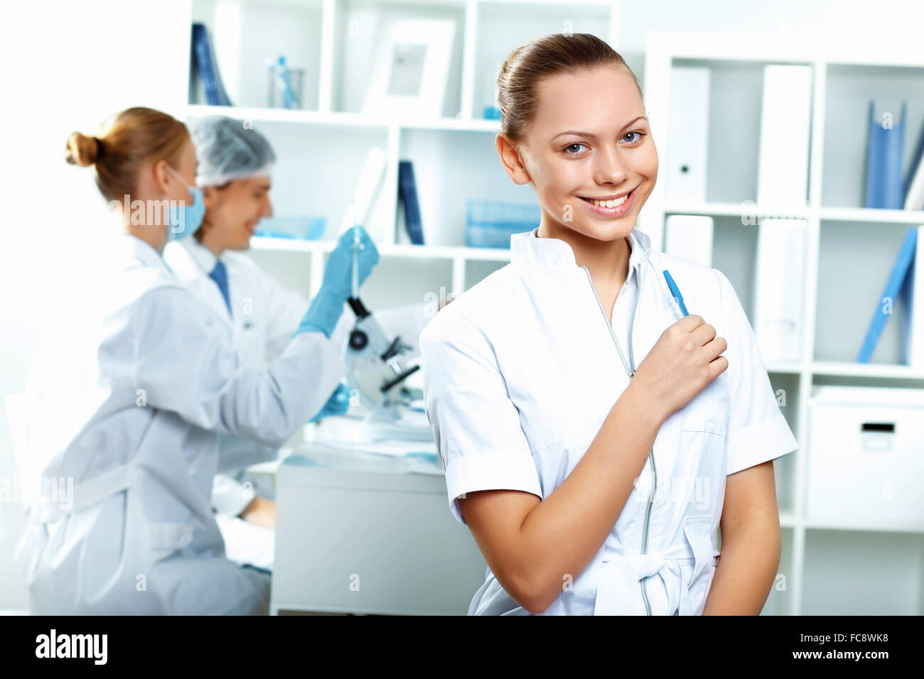 Young scientists in white uniform working in laboratory Stock Photo - Alamy