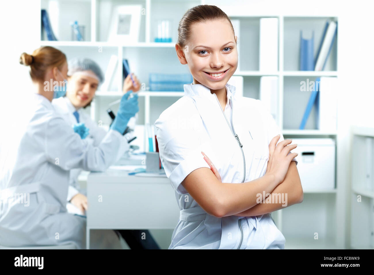 Young scientists in white uniform working in laboratory Stock Photo - Alamy