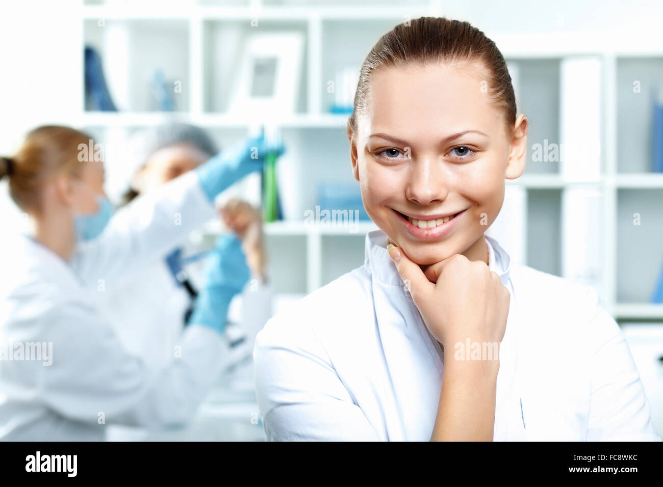 Young scientists in white uniform working in laboratory Stock Photo - Alamy