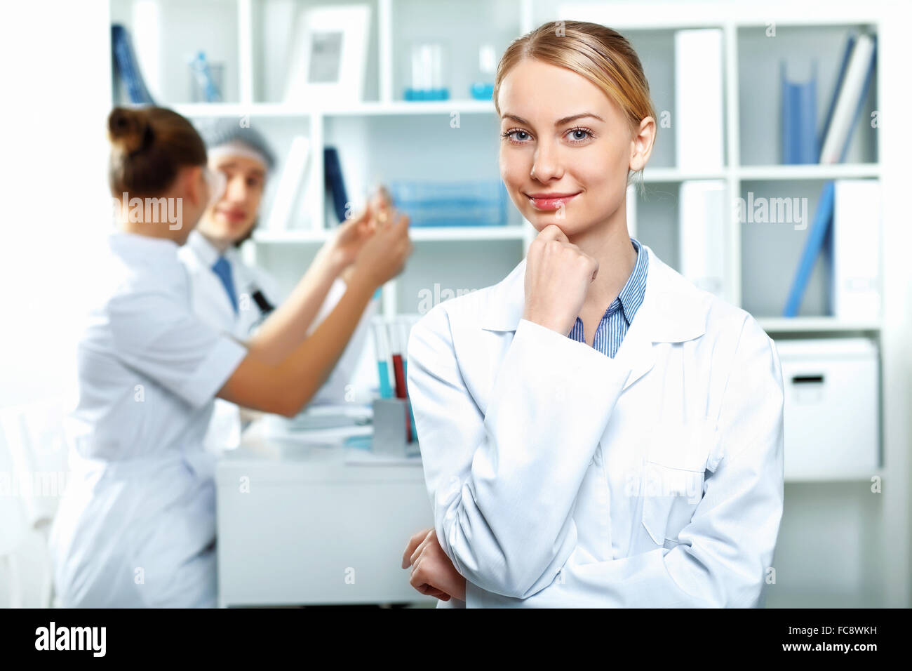 Young scientists in white uniform working in laboratory Stock Photo - Alamy