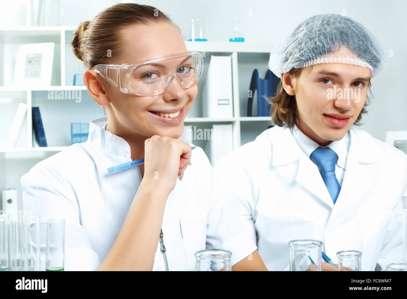 Young scientists in white uniform working in laboratory Stock Photo - Alamy