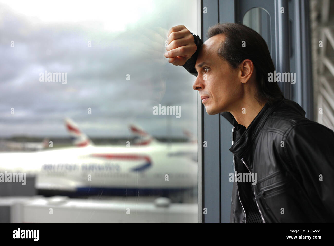 Thoughtful the man at a window Stock Photo - Alamy