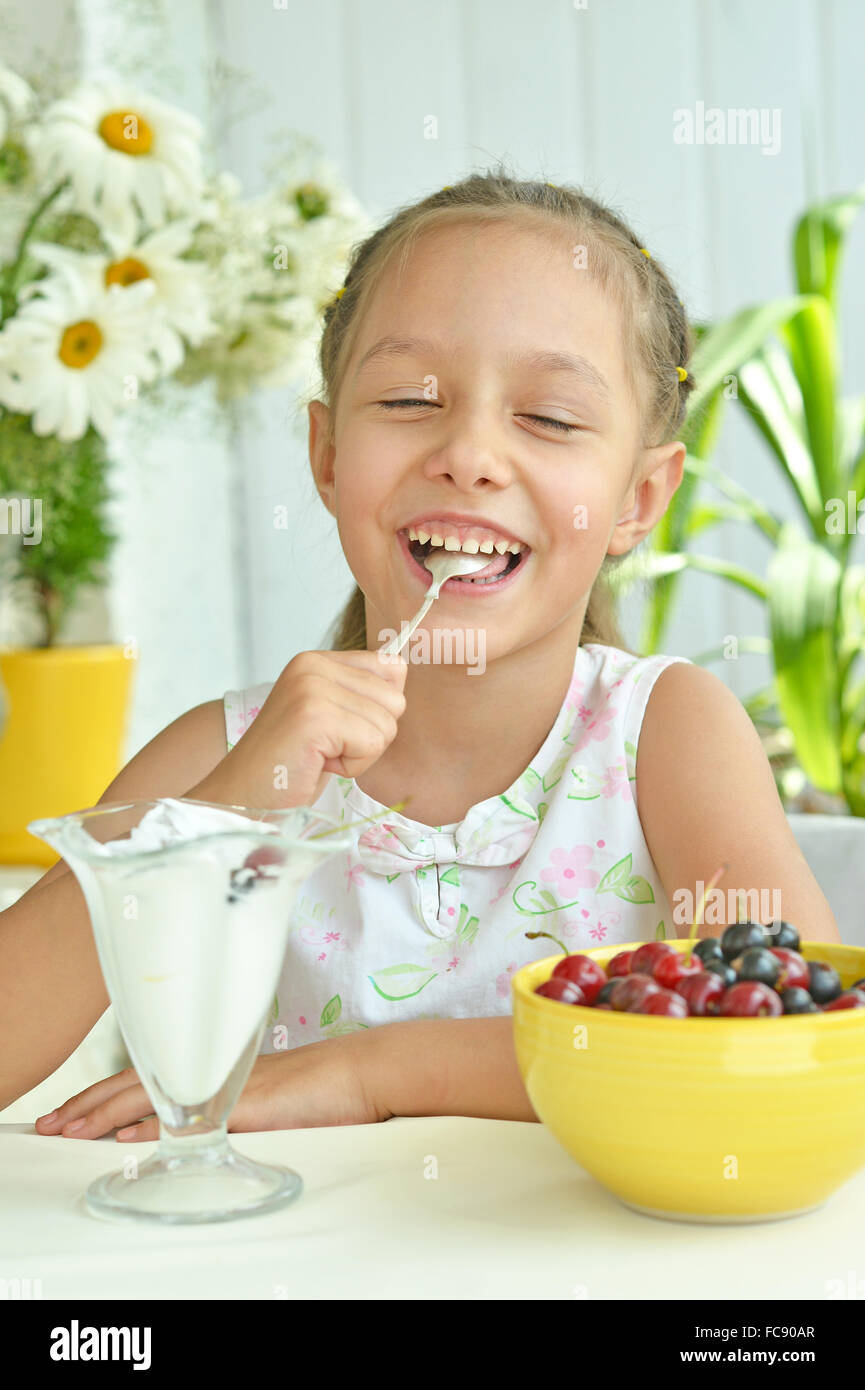 Girl eating sweet dessert with berries Stock Photo - Alamy