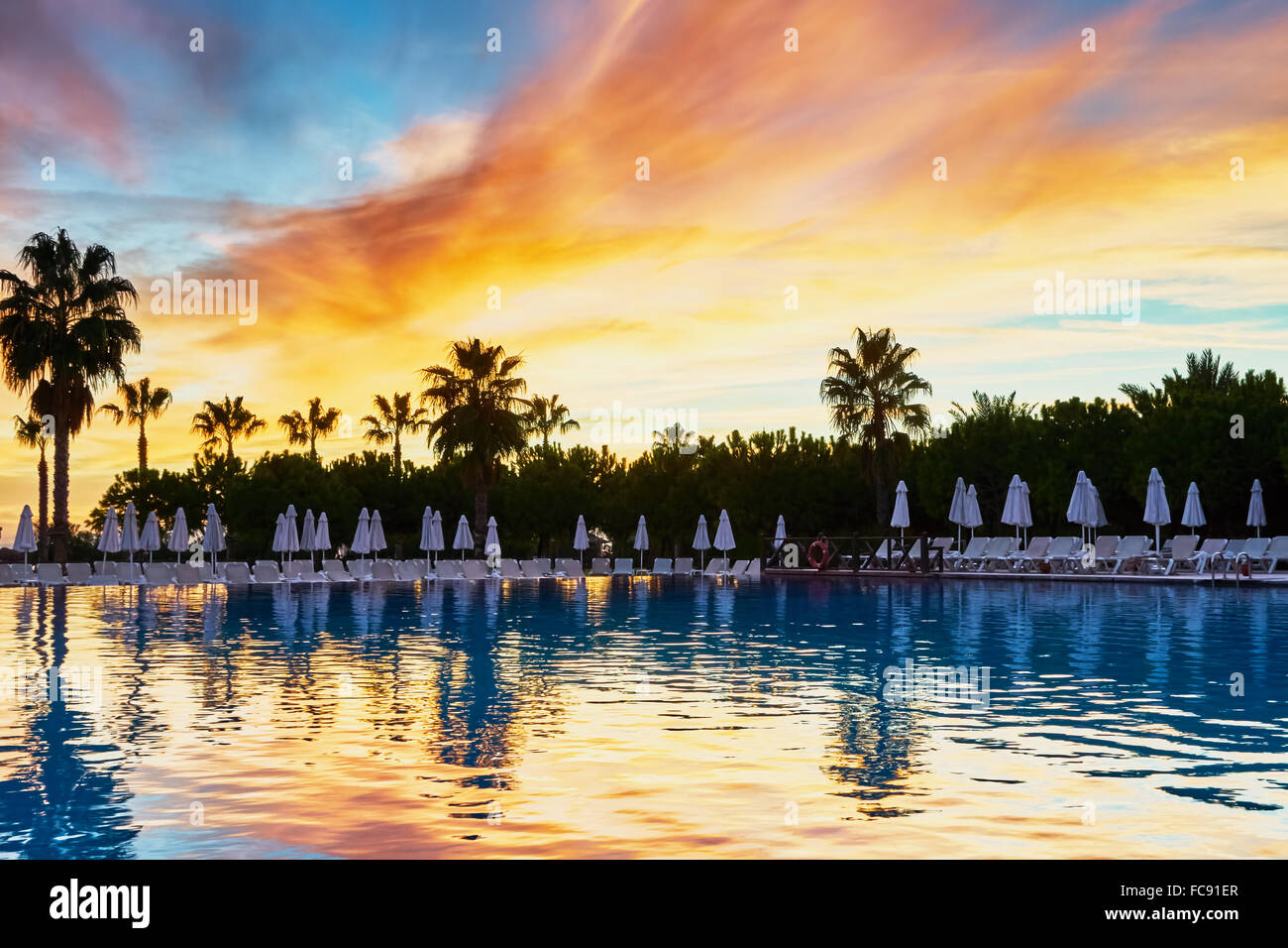 Sunset on the background of the pool Stock Photo - Alamy