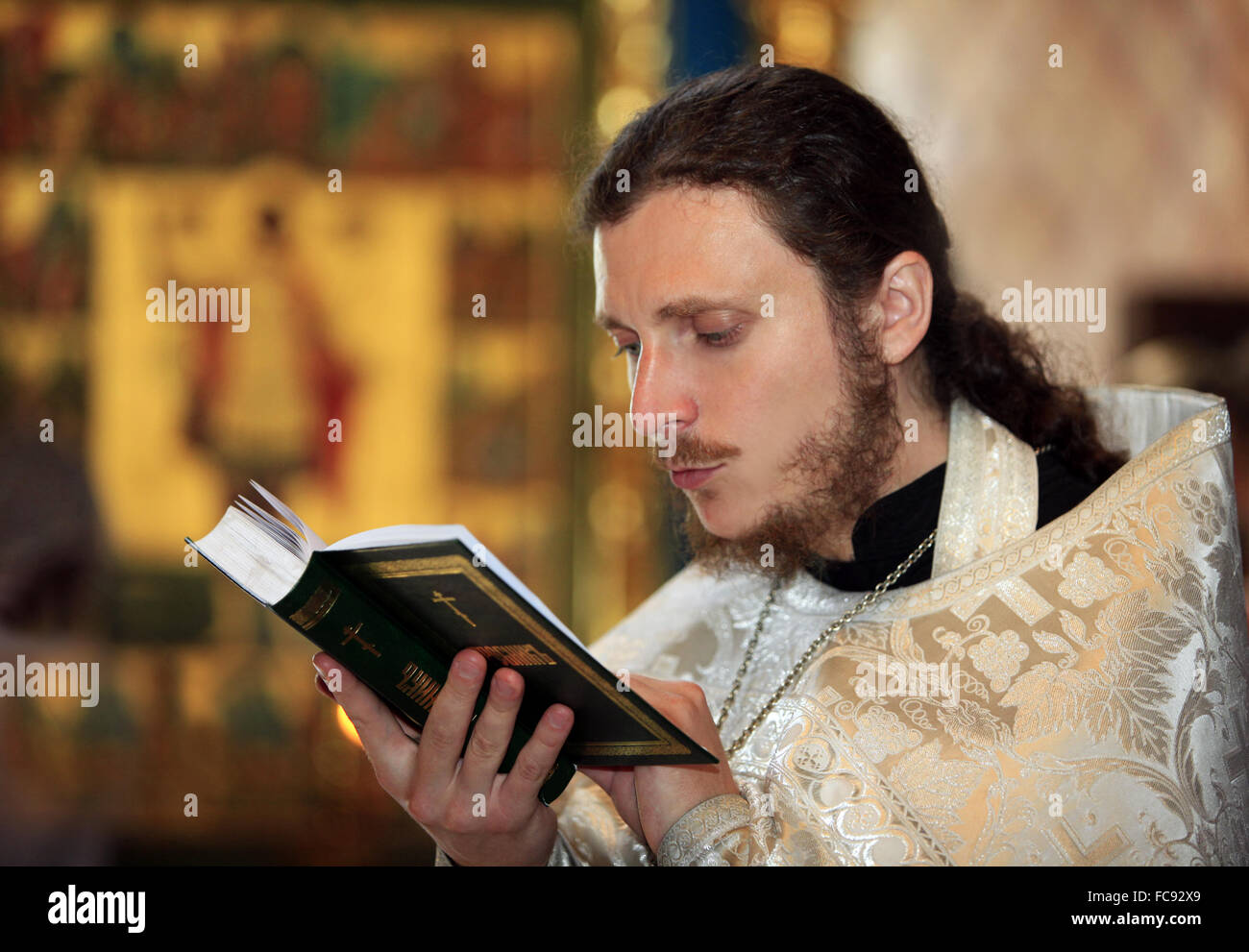 Priest with Bible Stock Photo - Alamy