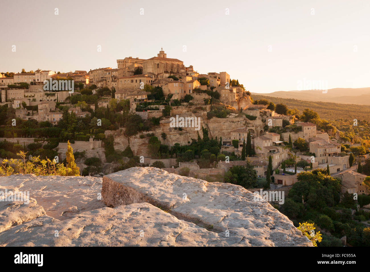 Hilltop village of Gordes with castle and church at sunrise, Provence ...