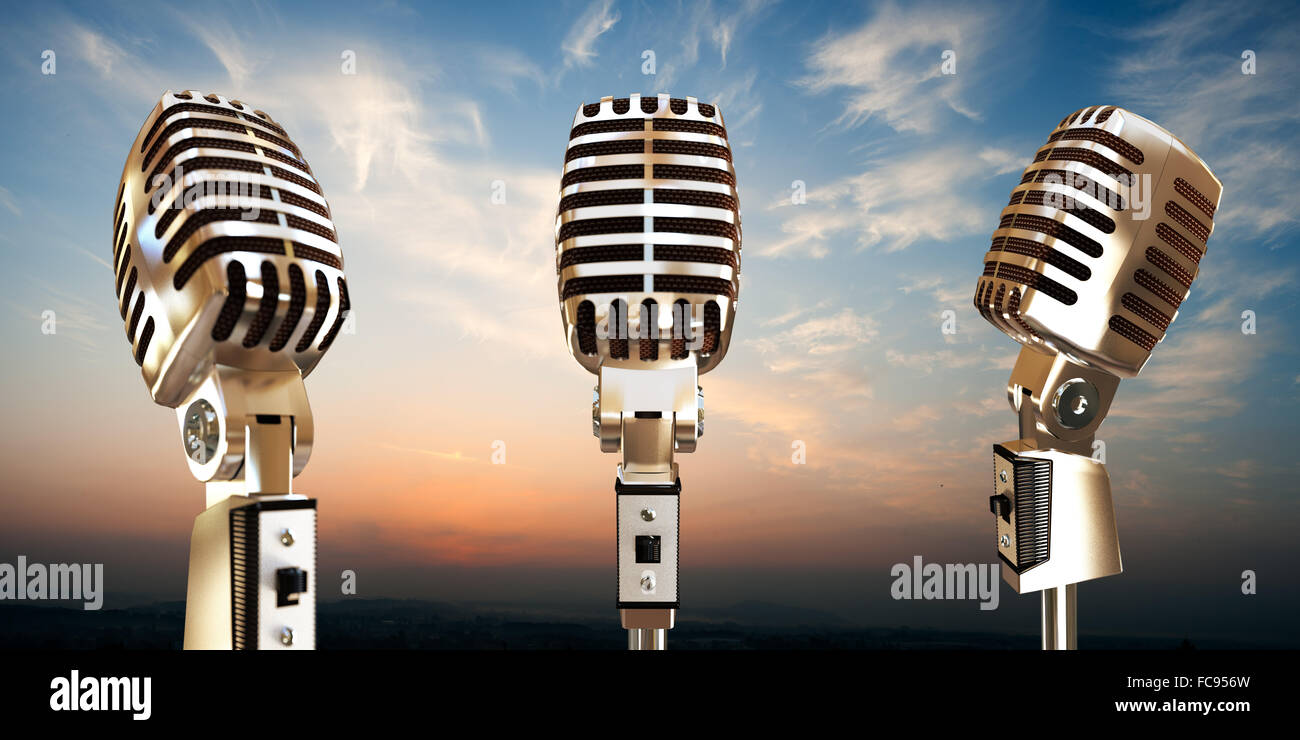 vintage microphones on sunset background Stock Photo - Alamy