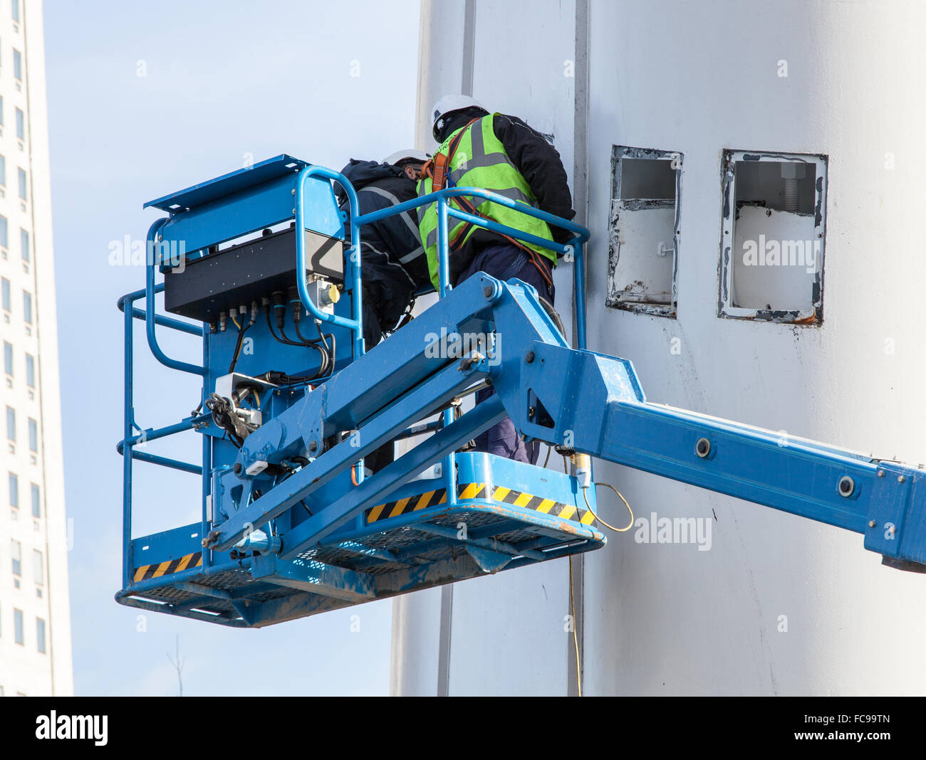 Manual worker on hydraulic lift Stock Photo - Alamy