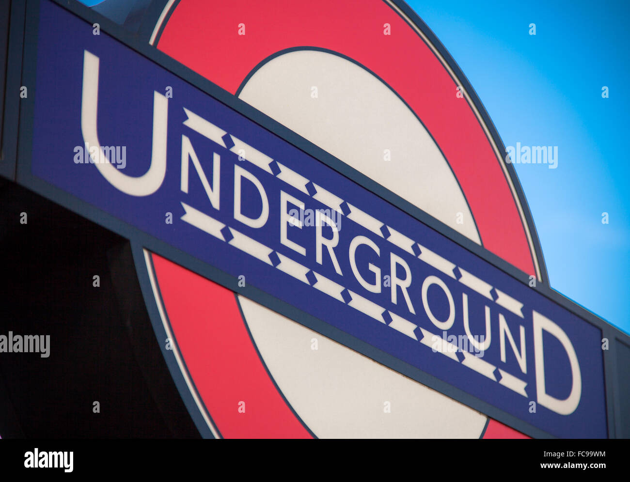 Iconic London underground sign in front of blue sky Stock Photo - Alamy