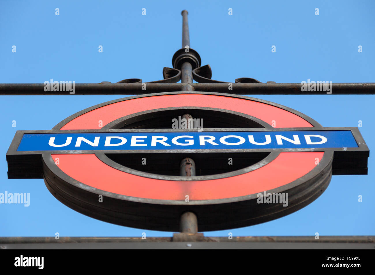 Iconic London underground sign in front of blue sky Stock Photo - Alamy