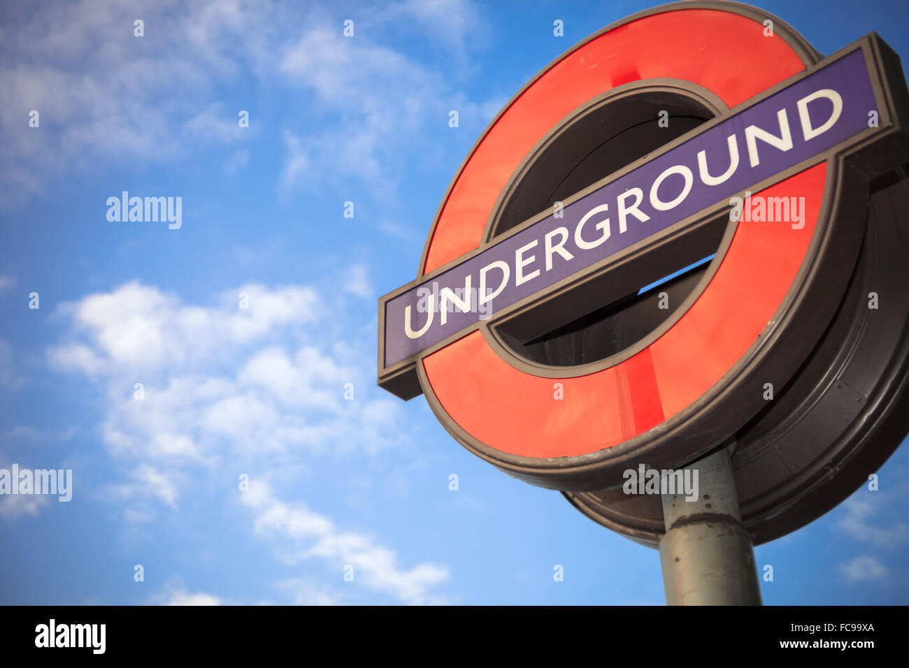 Iconic London underground sign in front of blue sky Stock Photo - Alamy