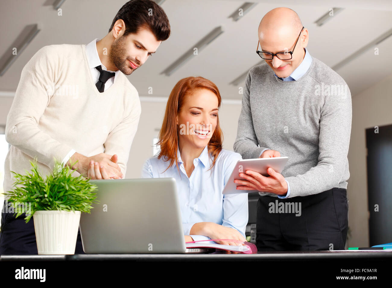 Business woman and her team continue discussion about cash flow ...
