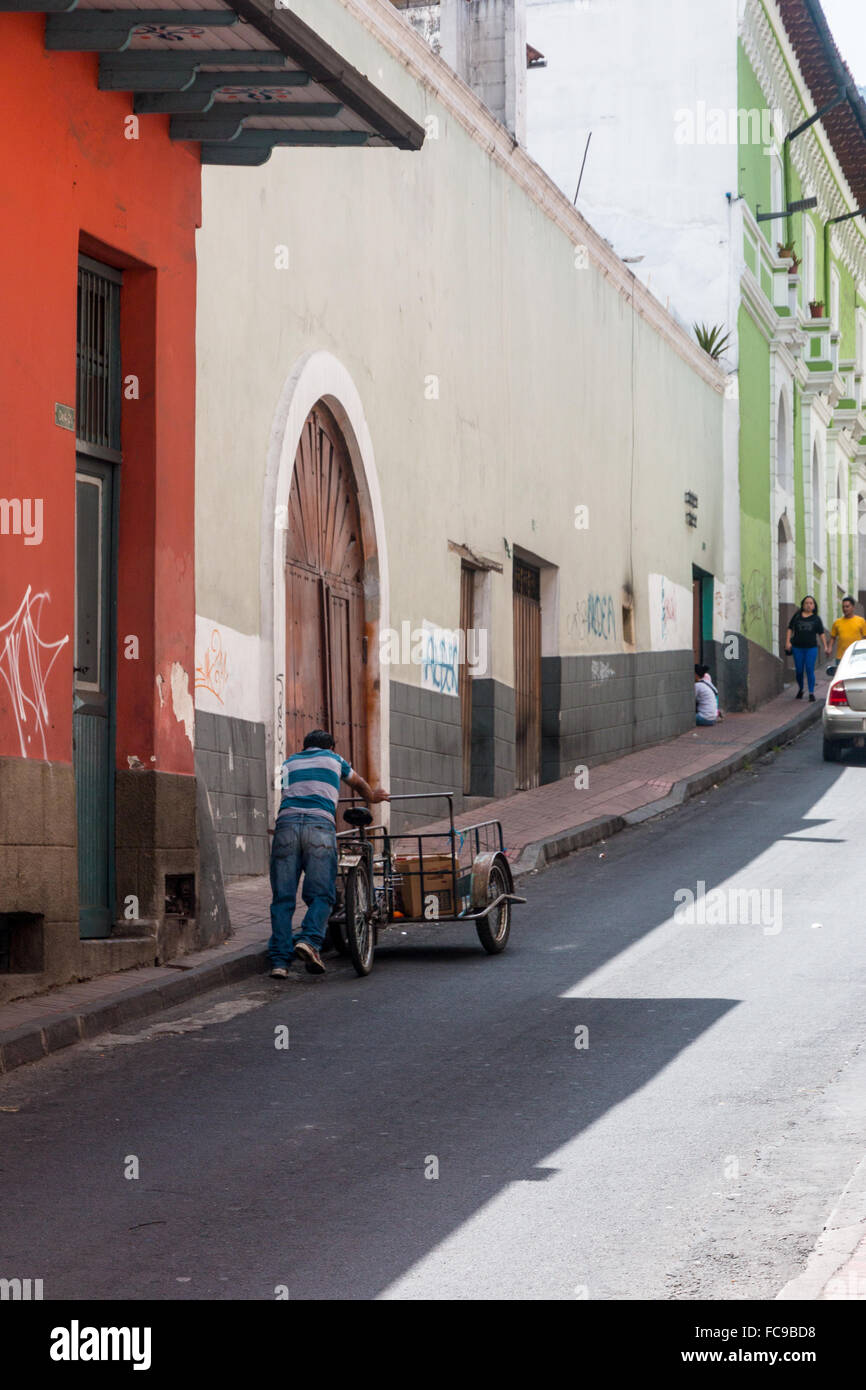 Man pushing cart in Old Town, Quito, Ecuador Stock Photo - Alamy
