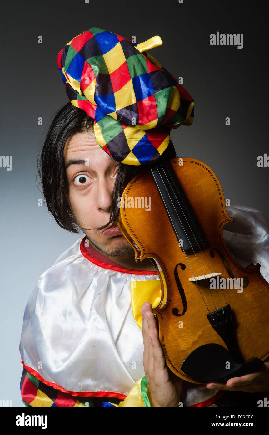 Funny violin clown player in musical concept Stock Photo - Alamy
