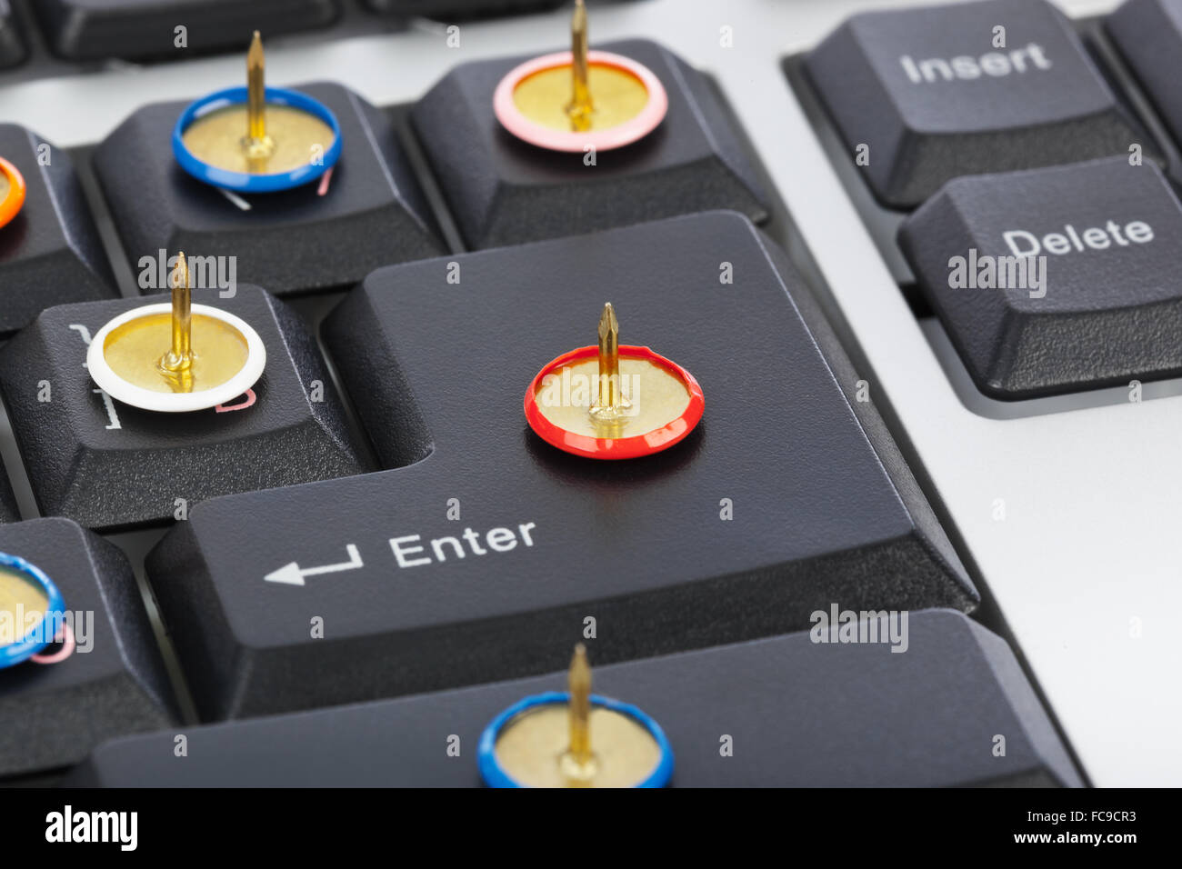 Pins on computer keyboard Stock Photo - Alamy
