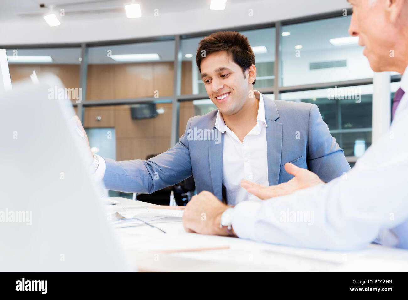 Two businessman in office having discussion Stock Photo - Alamy
