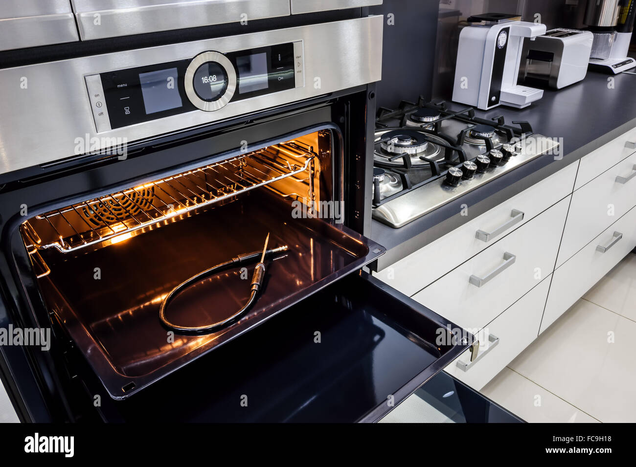 Modern hi-tek kitchen, oven with door open Stock Photo - Alamy