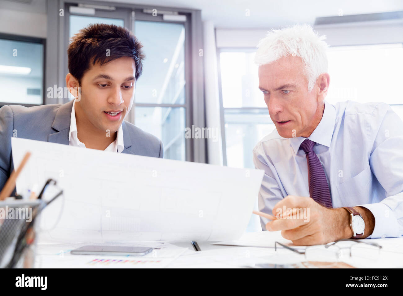 Two businessman in office having discussion Stock Photo - Alamy