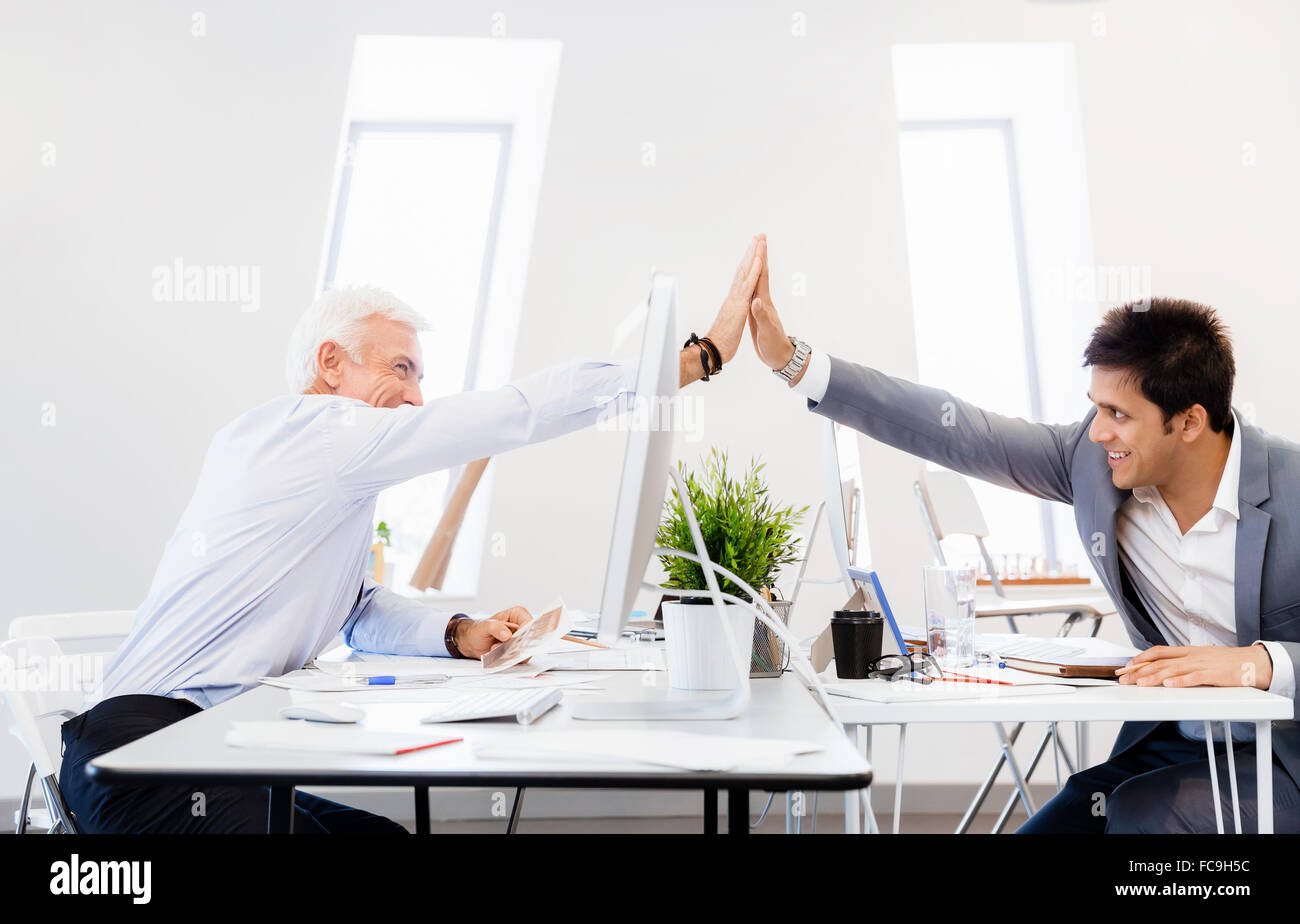 Businessmen in office cheering at their success Stock Photo - Alamy