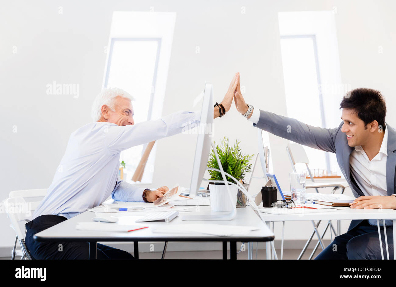 Businessmen in office cheering at their success Stock Photo - Alamy