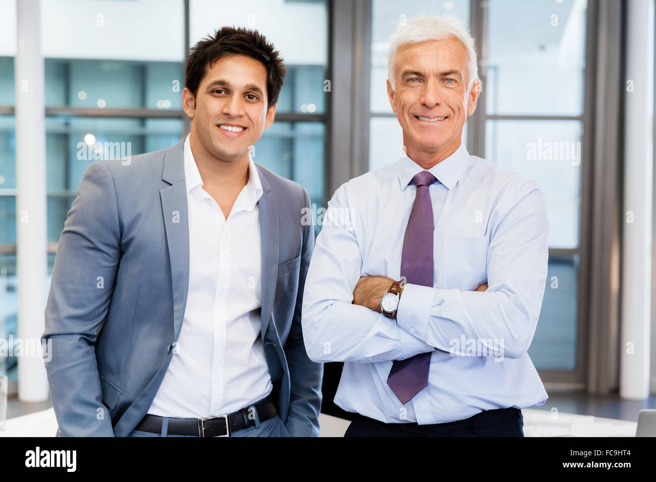 Two businessmen in office standing Stock Photo - Alamy