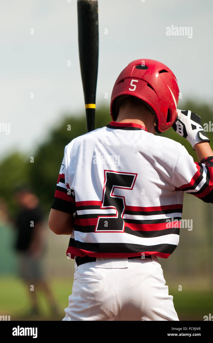 Little league baseball player getting ready to bat looking down Stock ...