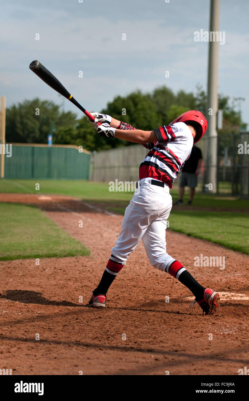 Little league baseball player at the plate, swinging the baseball bat ...