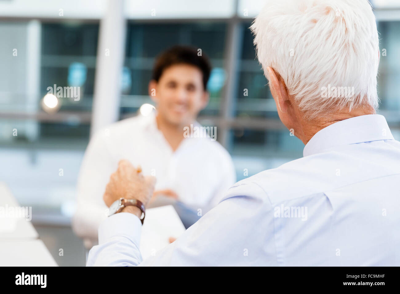 Two businessmen during interview in office Stock Photo - Alamy