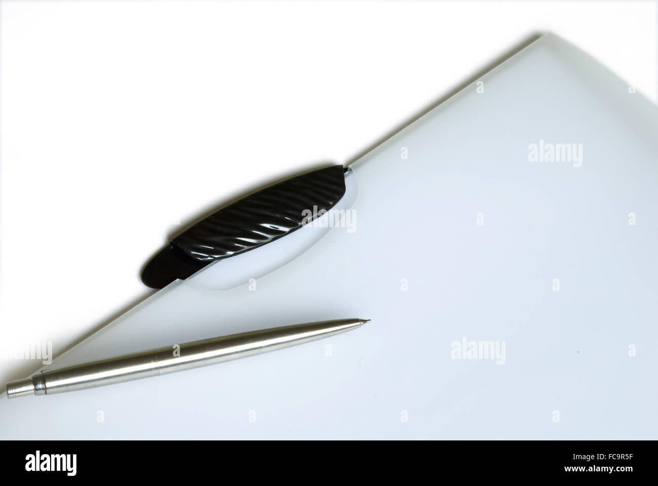 White folder with clip and pen Stock Photo - Alamy