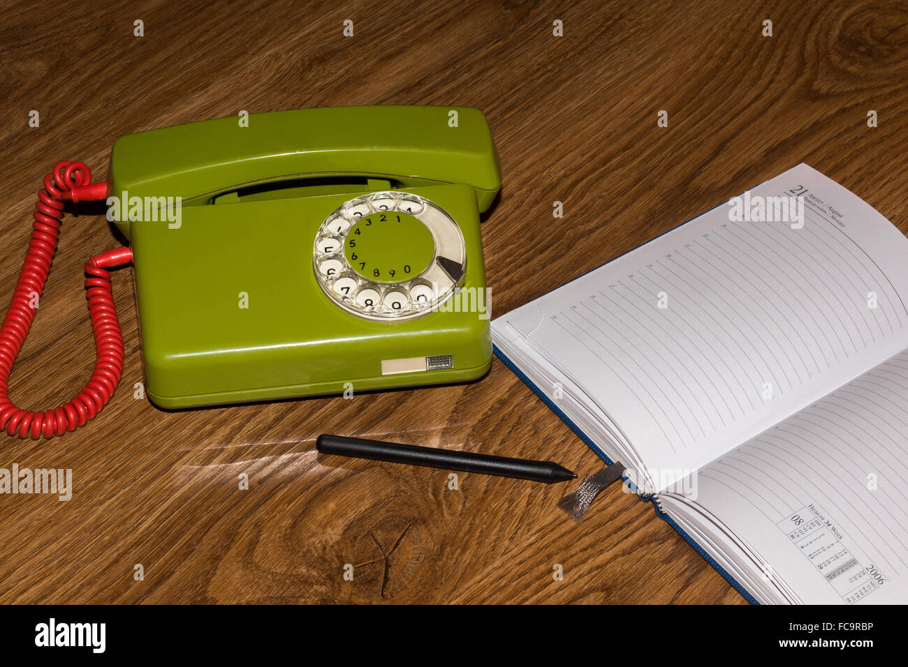 The photo depicts a landline phone with a notebook Stock Photo - Alamy