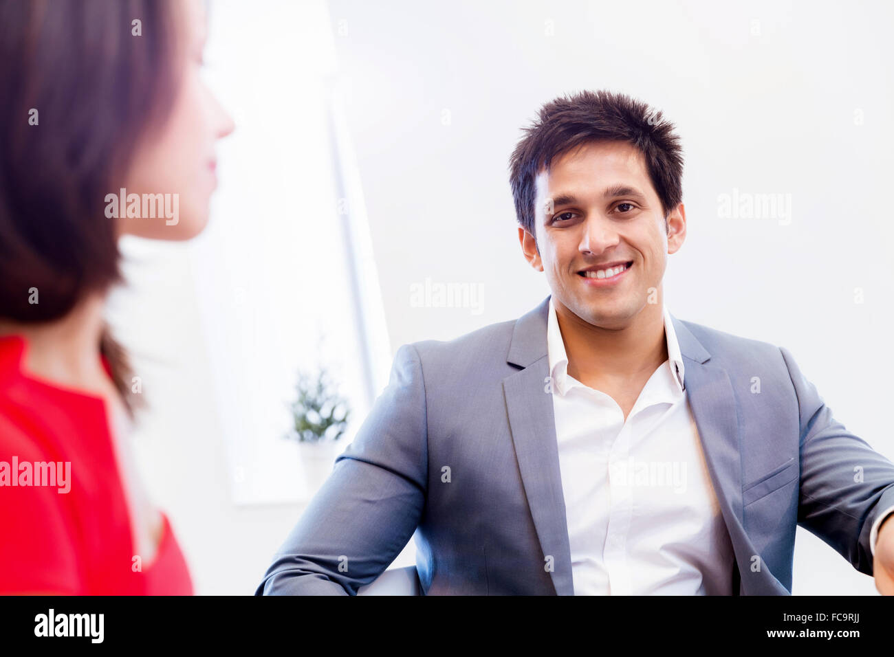 Two young business collegue talking in office Stock Photo - Alamy
