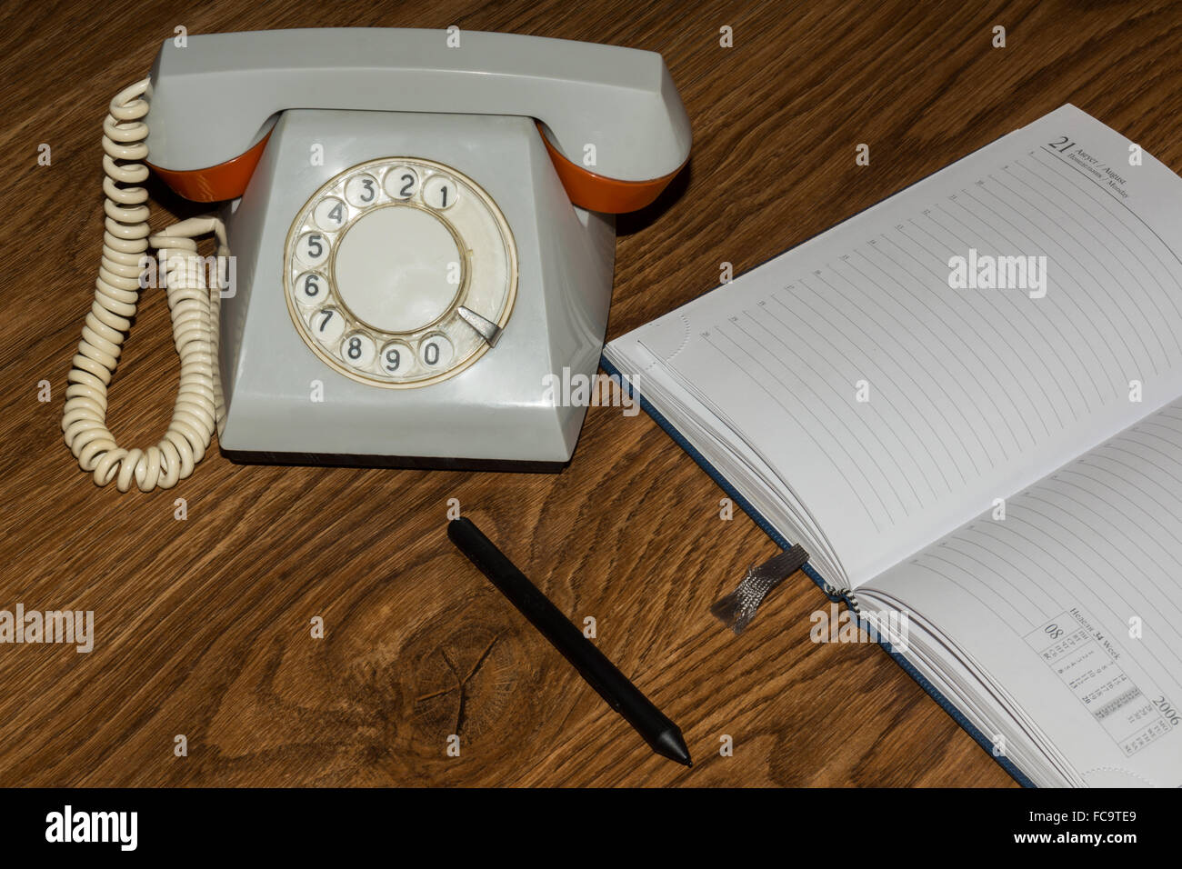 The photo depicts a landline phone with a notebook Stock Photo - Alamy