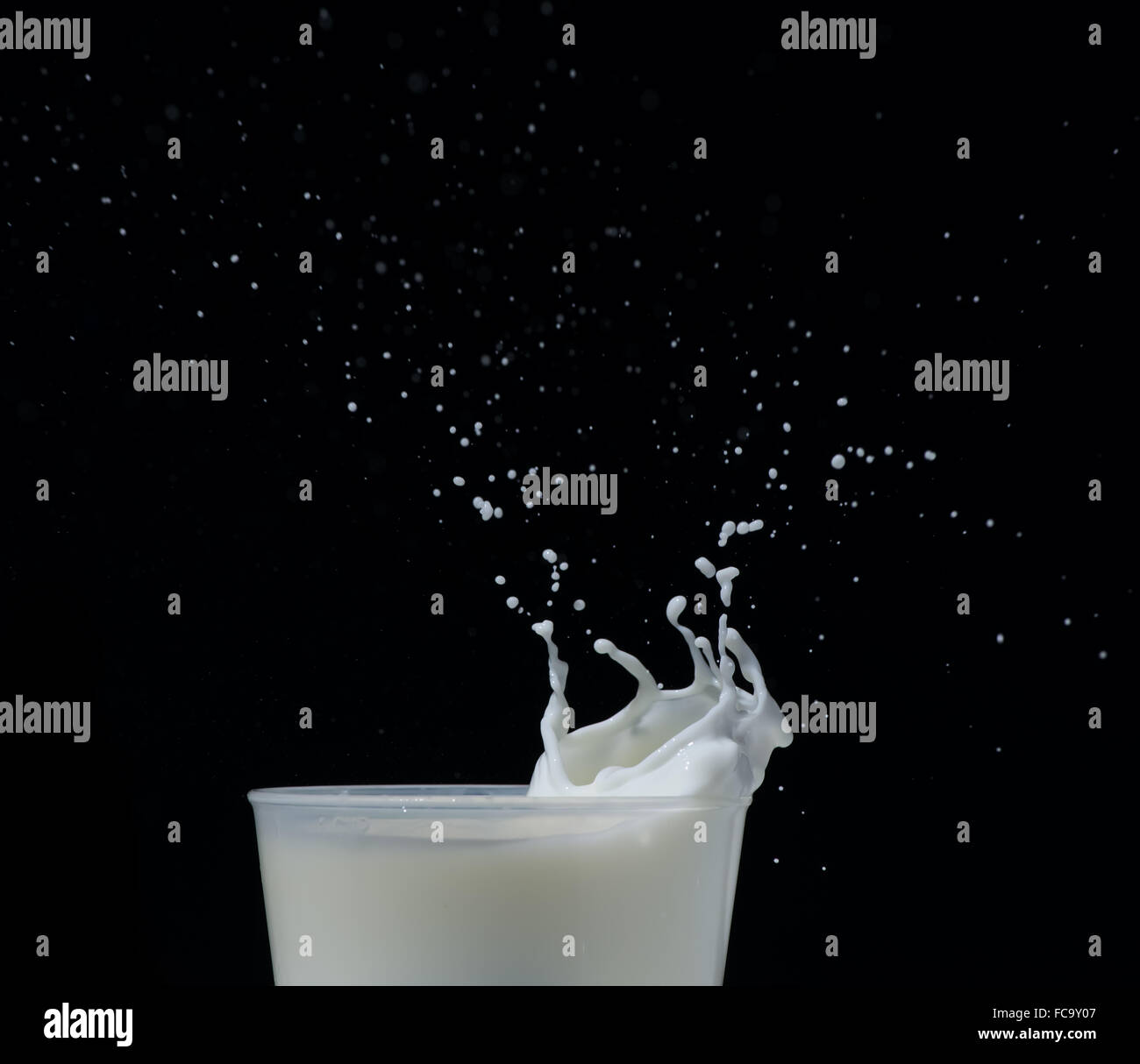 Splashing milk black isolated Stock Photo - Alamy