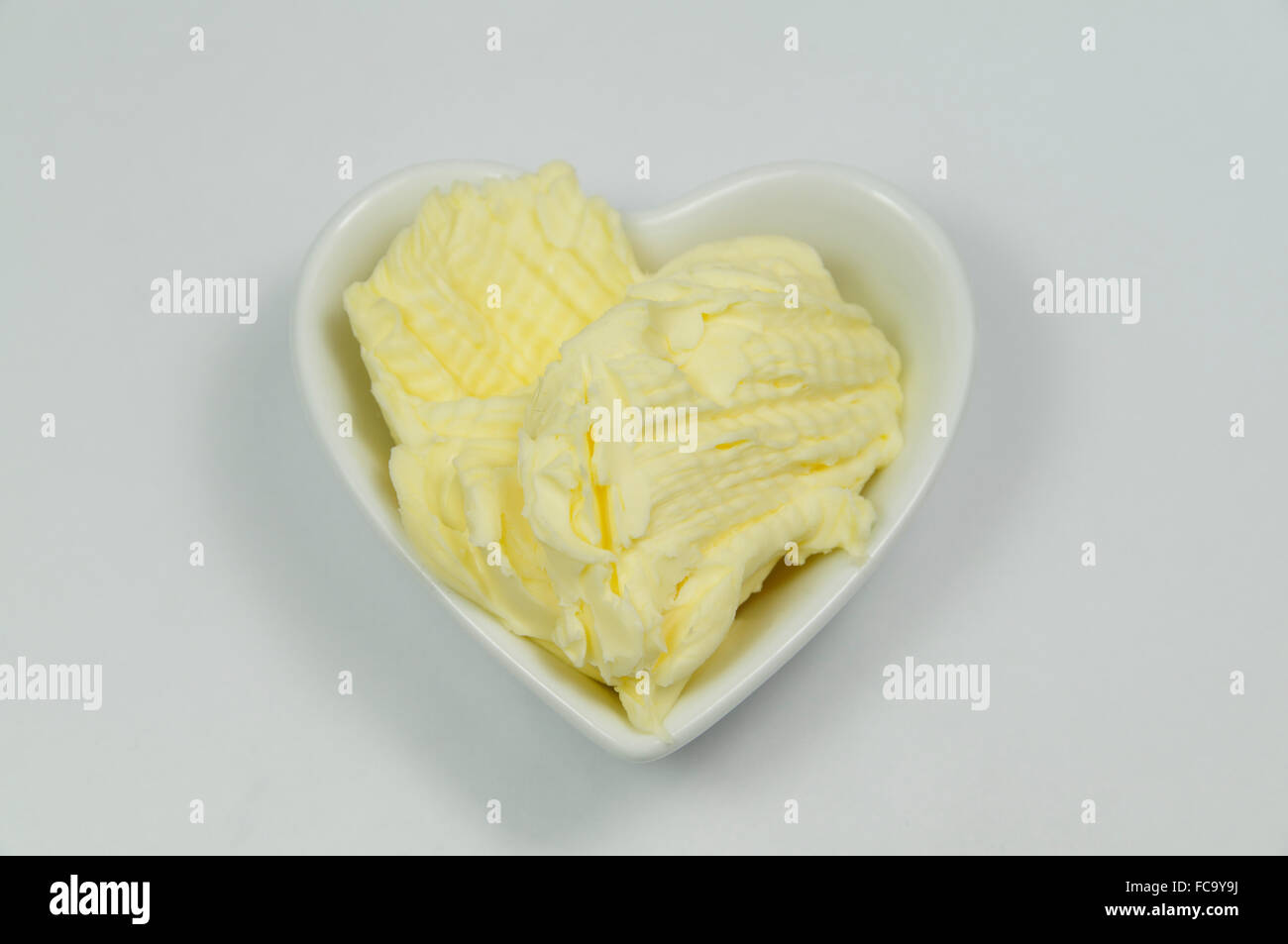 Butter in heart shaped dish Stock Photo - Alamy