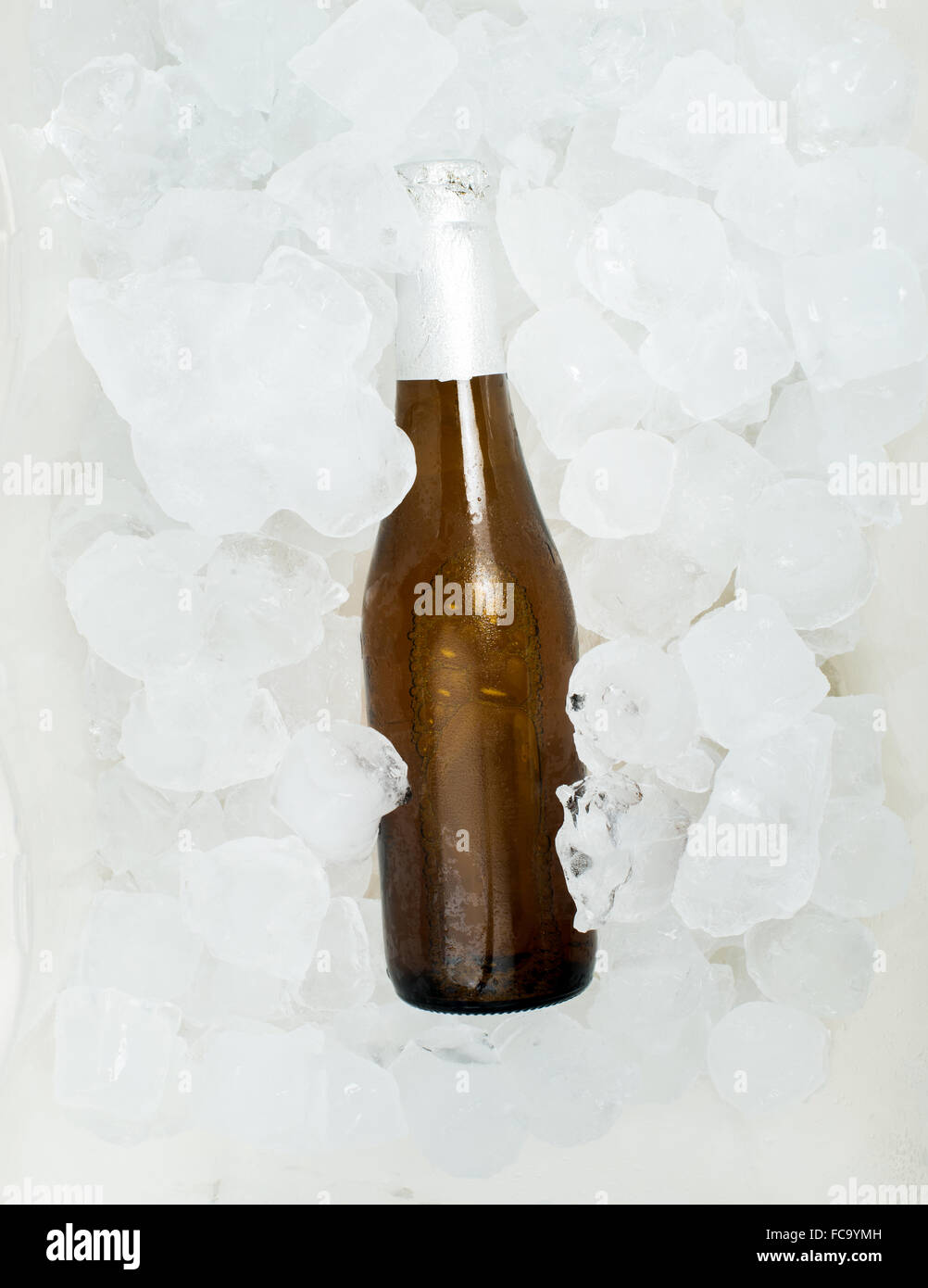 Bottle of beer and ice cubes Stock Photo - Alamy