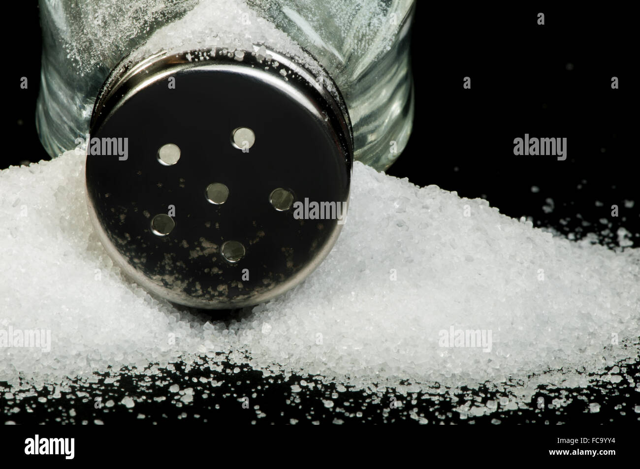 Salt on black background Stock Photo - Alamy