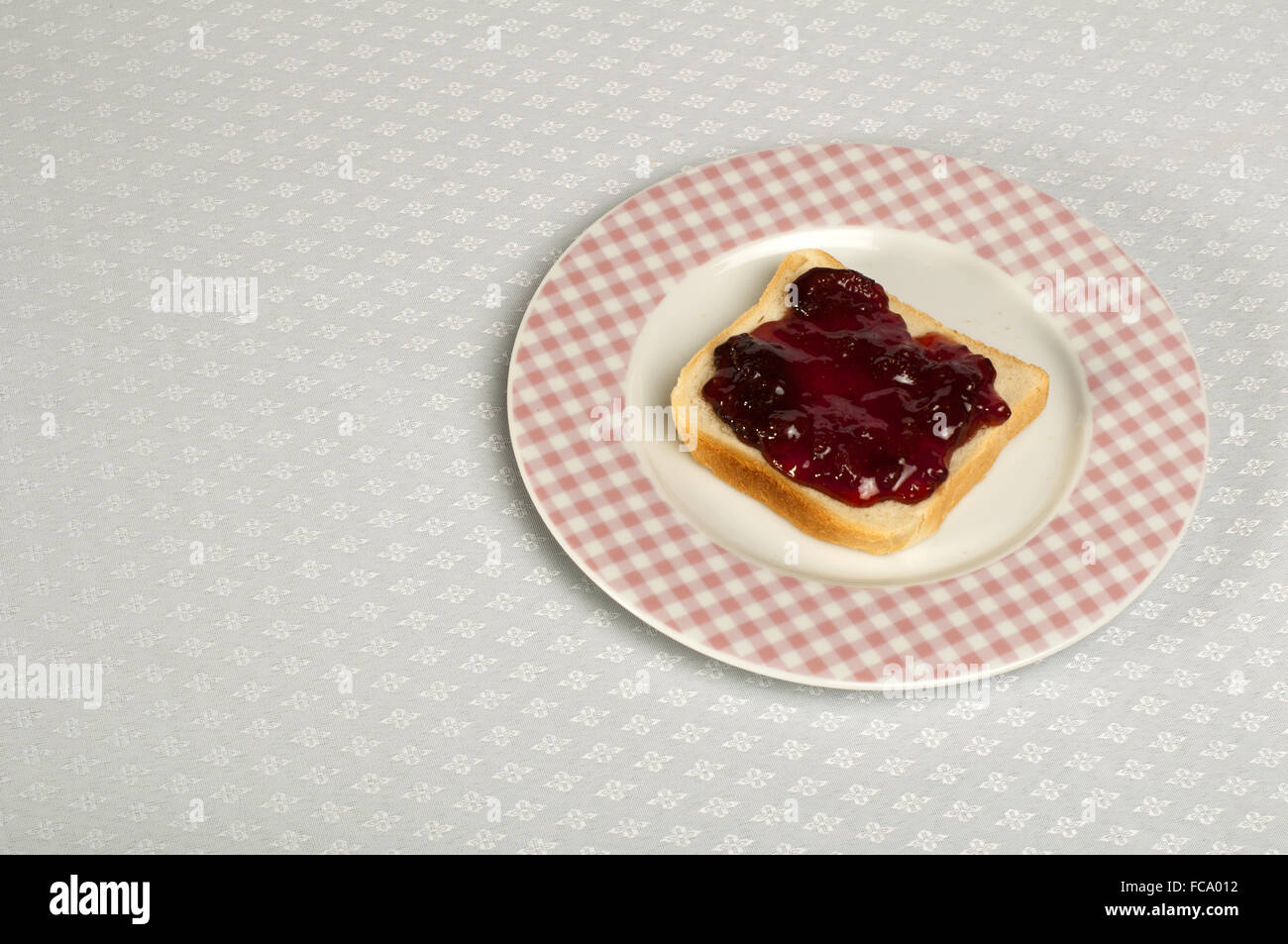 Spread jam on bread Stock Photo - Alamy
